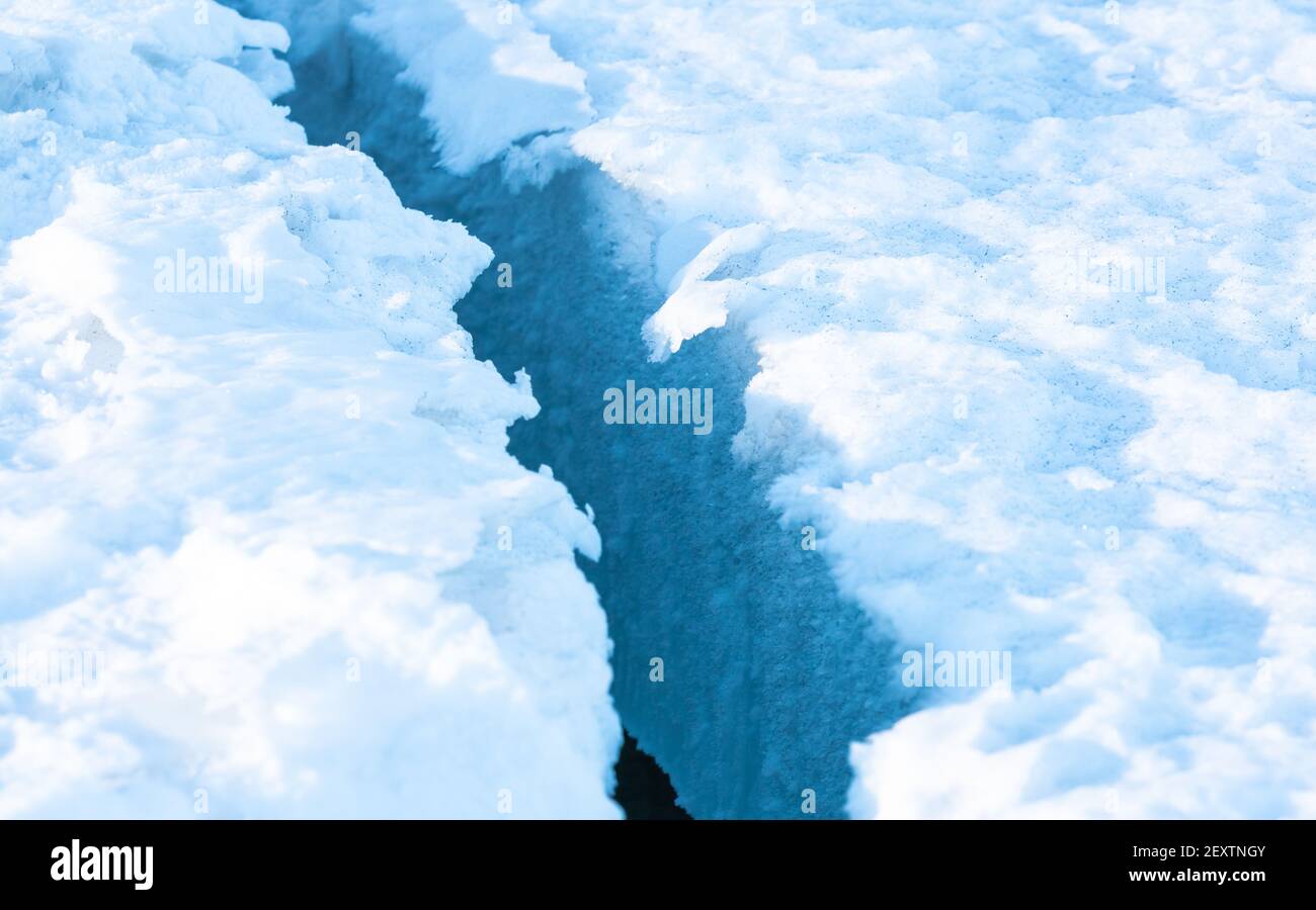 Large clean crack in sea ice with white snow on the top Stock Photo - Alamy