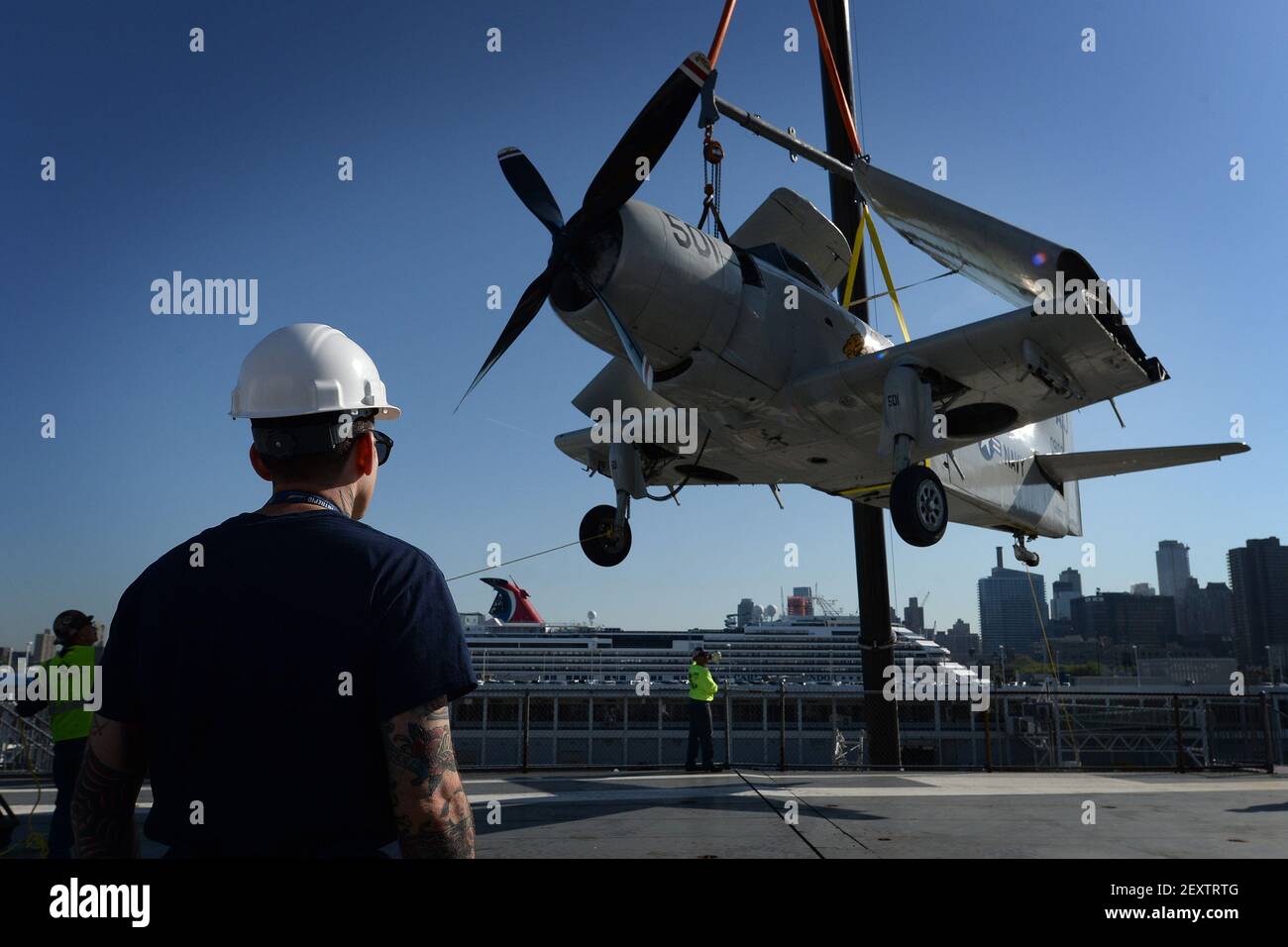 Douglas A-1 Skyraider is moved onto the flight deck of the Intrepid Sea ...