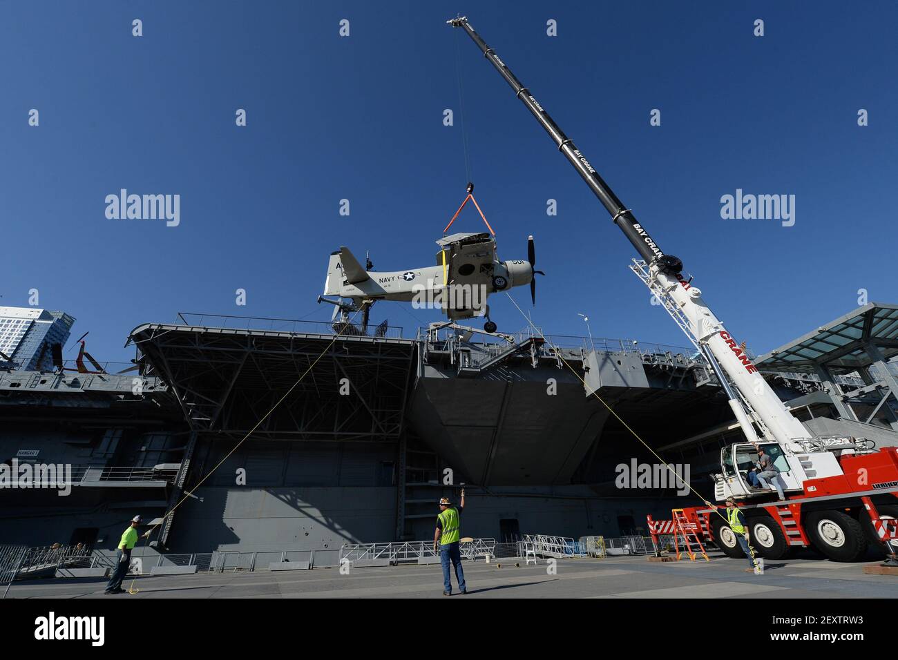 Douglas A-1 Skyraider is moved onto the flight deck of the Intrepid Sea ...