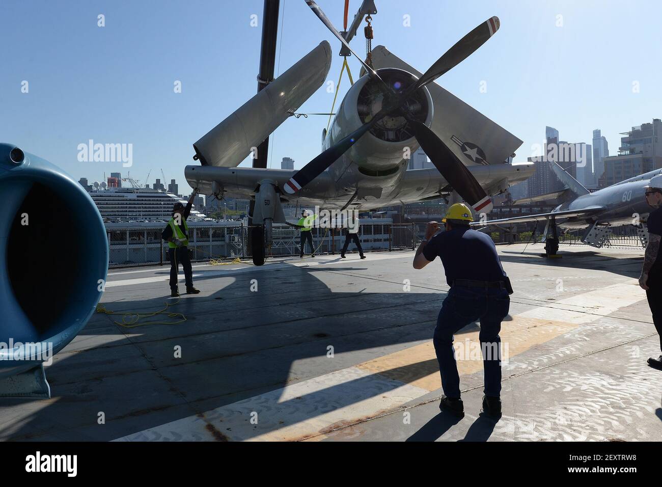 A Douglas A-1 Skyraider is moved onto the flight deck of the Intrepid ...