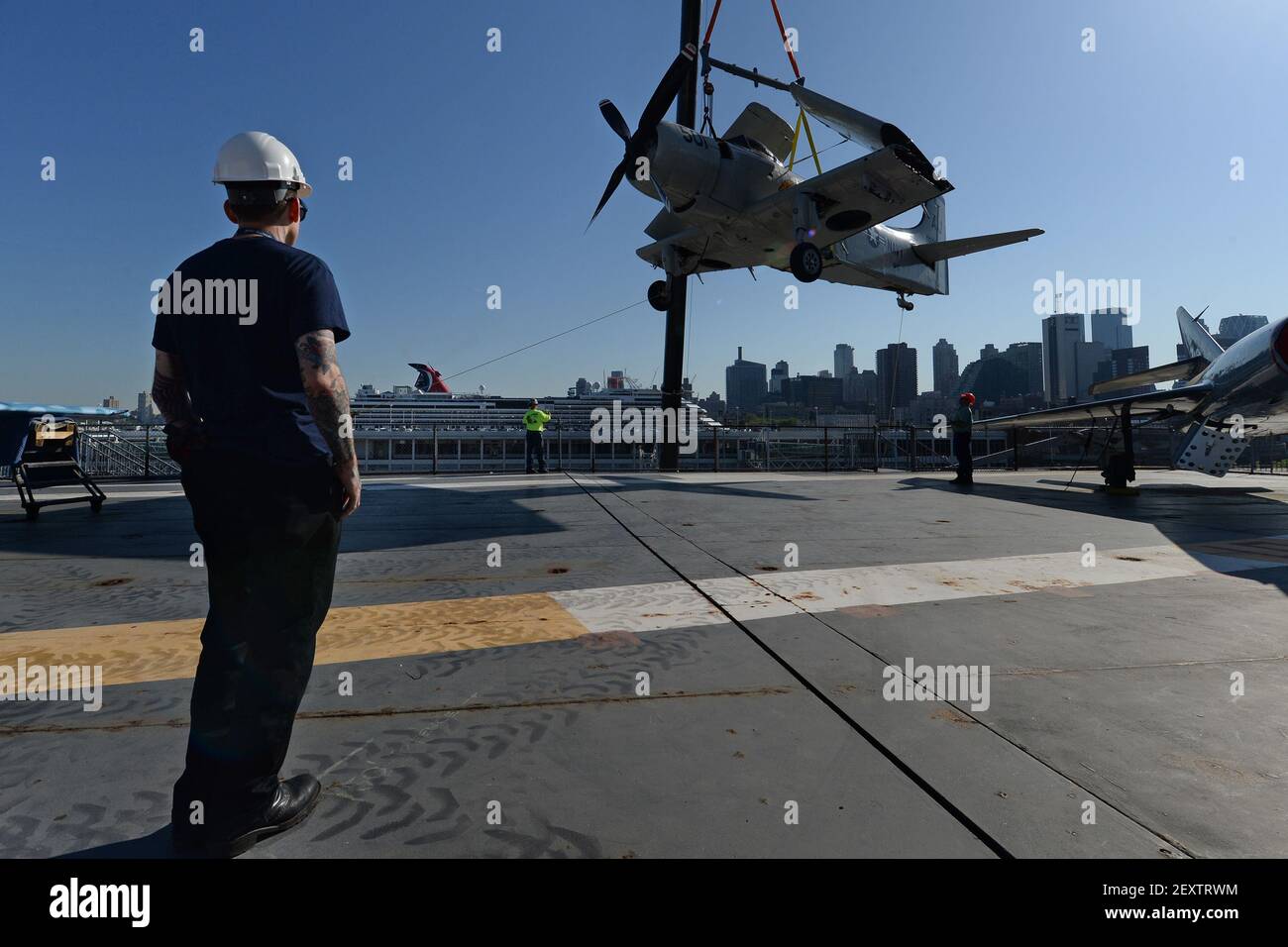 Douglas A-1 Skyraider is moved onto the flight deck of the Intrepid Sea ...