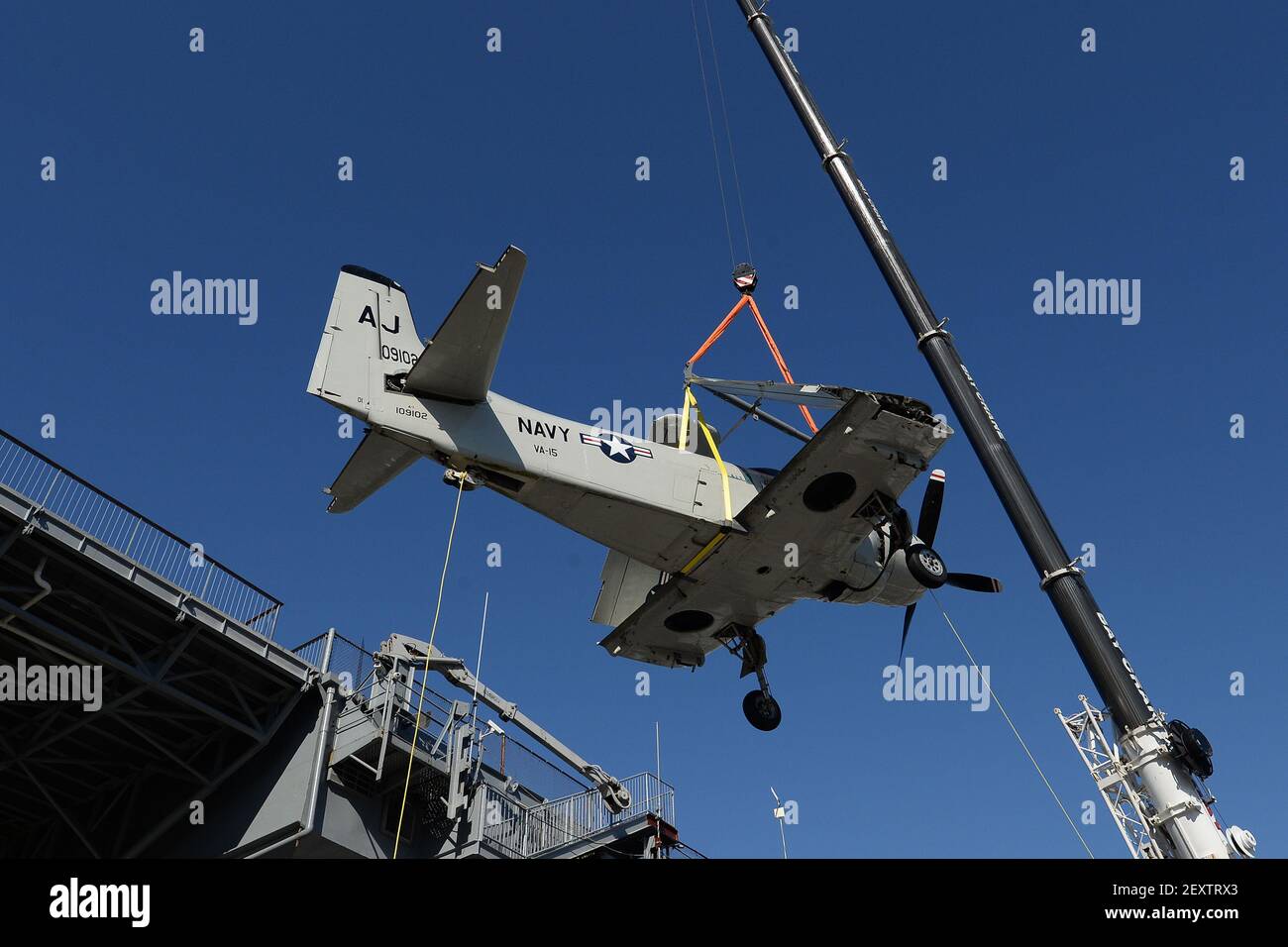 A Douglas A-1 Skyraider is moved onto the flight deck of the Intrepid ...
