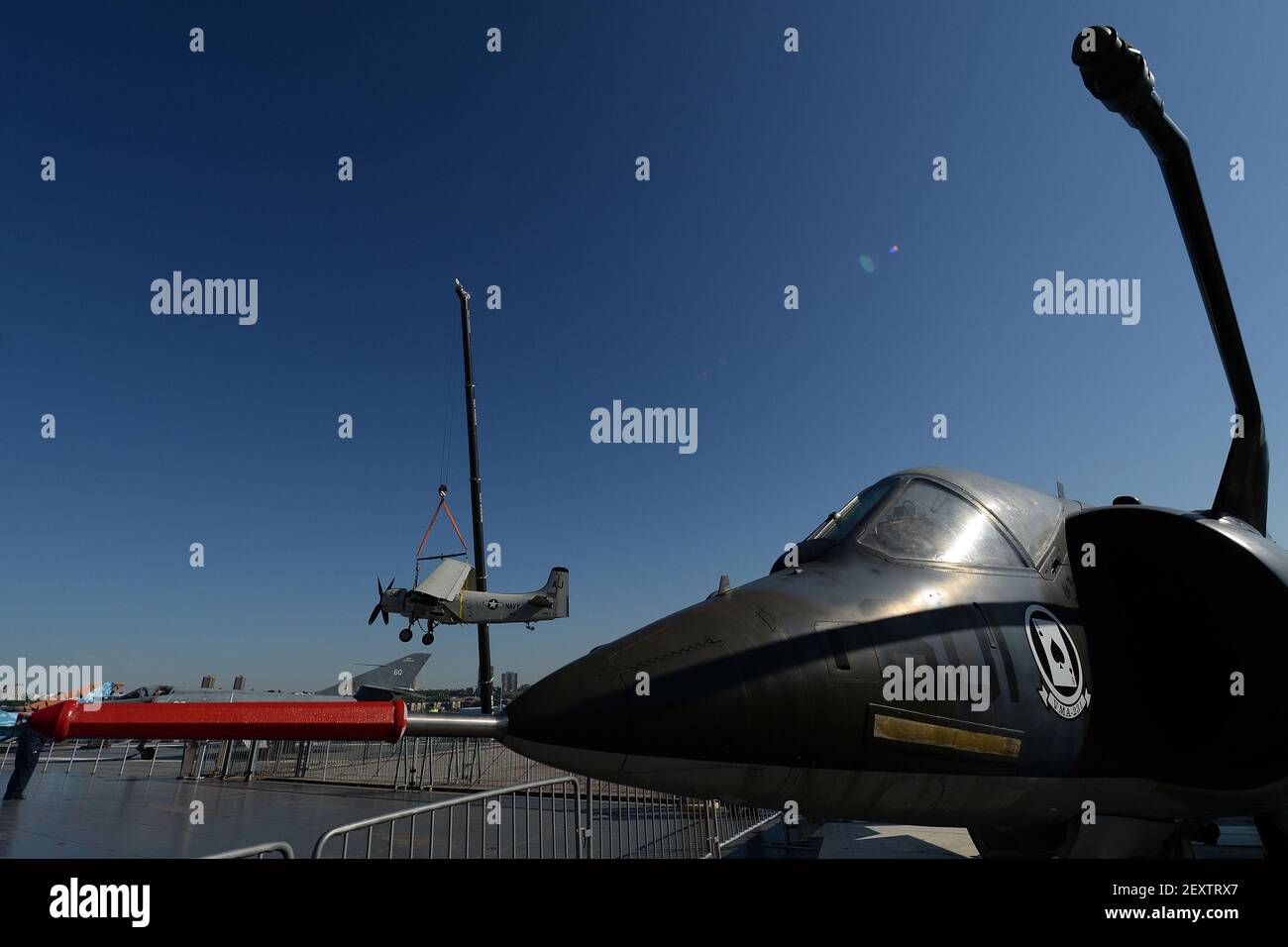 Douglas A-1 Skyraider is moved onto the flight deck of the Intrepid Sea ...
