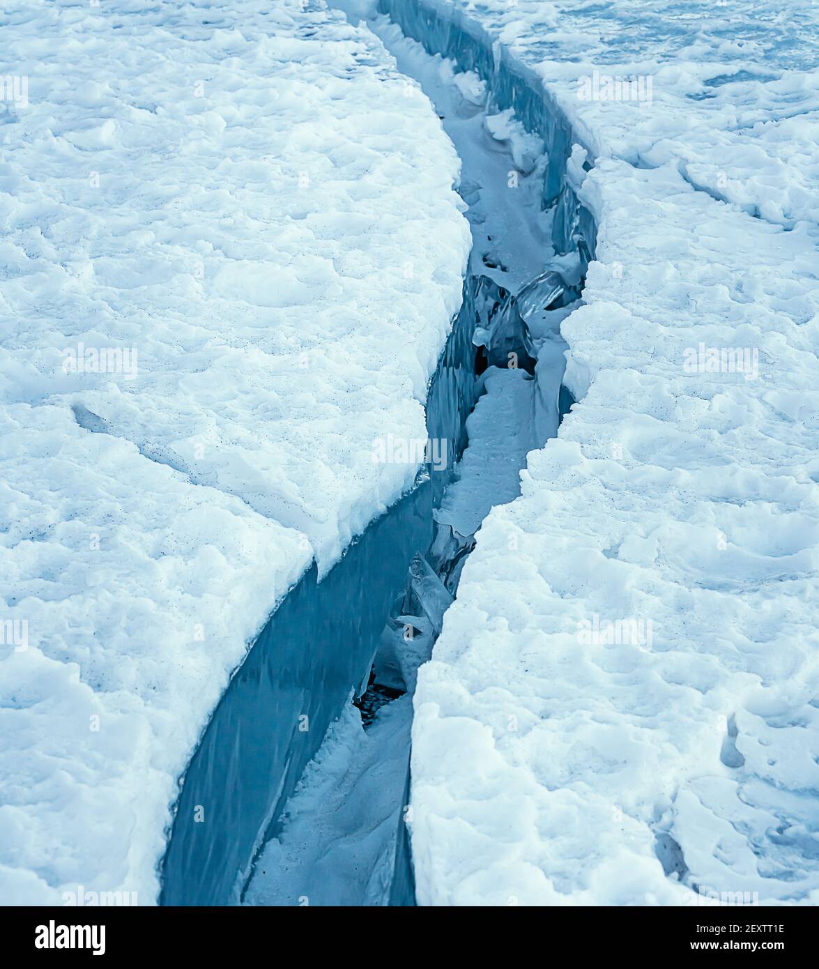 Large clean crack in sea ice with white snow on the top Stock Photo - Alamy