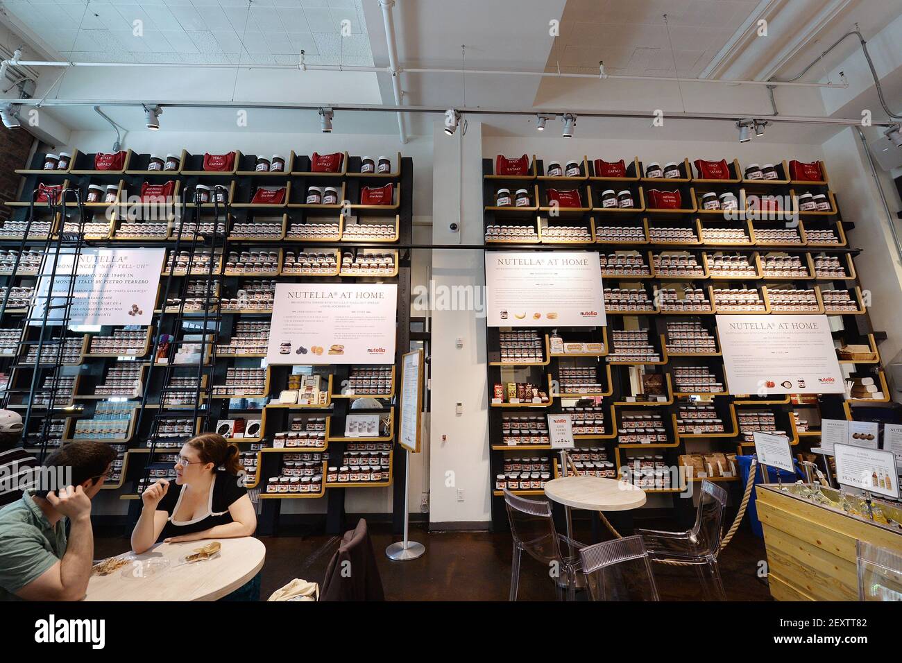 A row of Nutella jars, a hazelnut chocolate spread, lines the walls ...