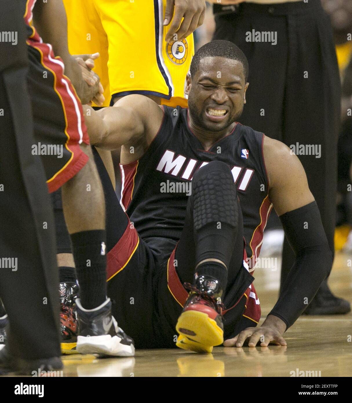 The Miami Heat's Dwayne Wade grimaces in pain after taking a hard fall ...