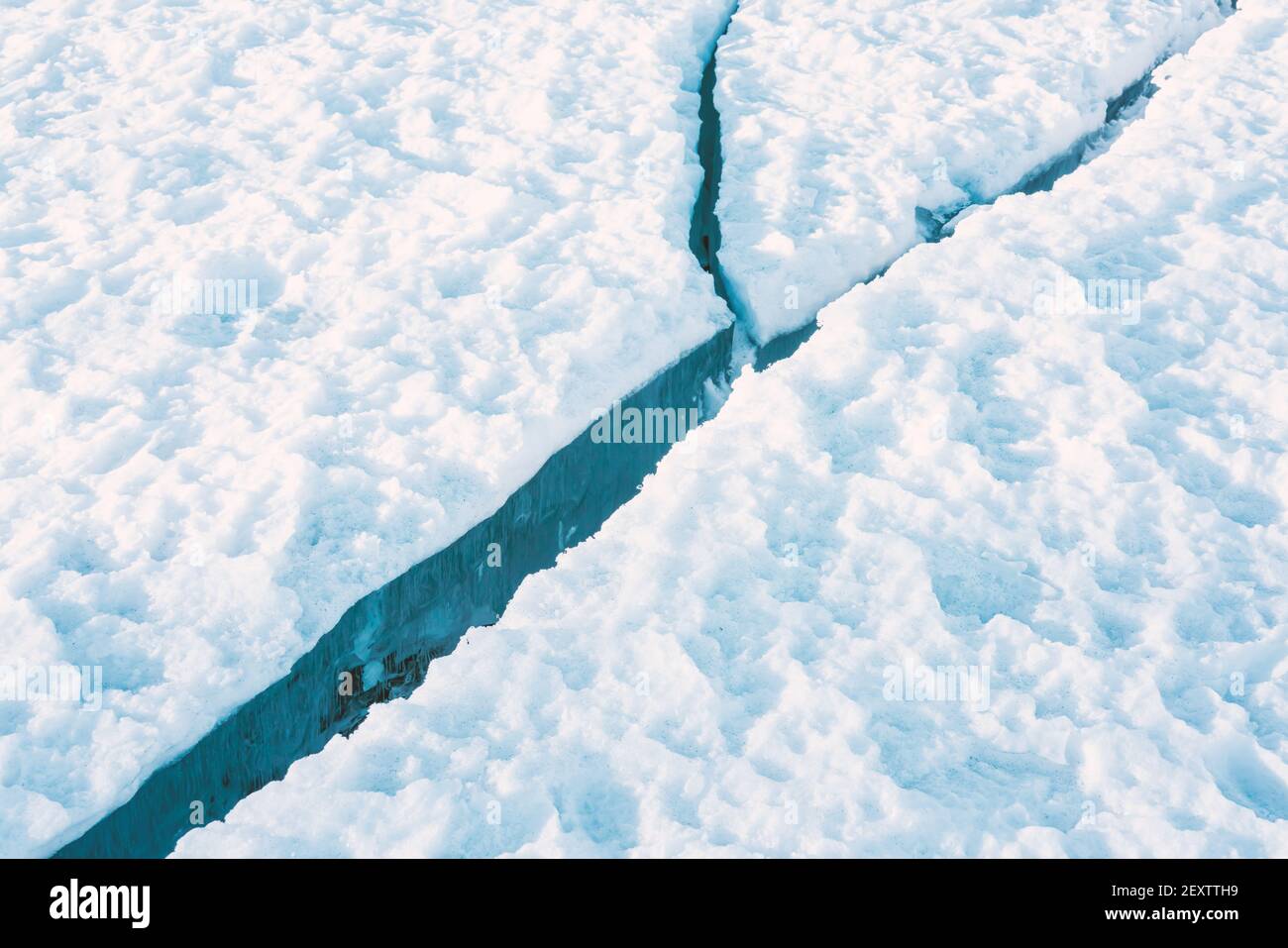 Large clean crack in sea ice with white snow on the top Stock Photo - Alamy
