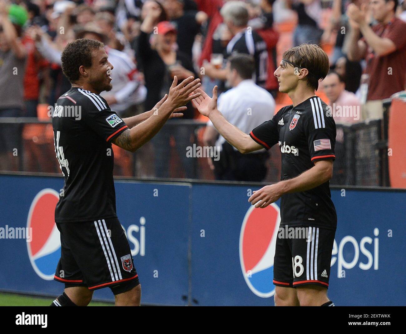 D.C. United midfielder Nick DeLeon (14) congratulates teammate Chris ...