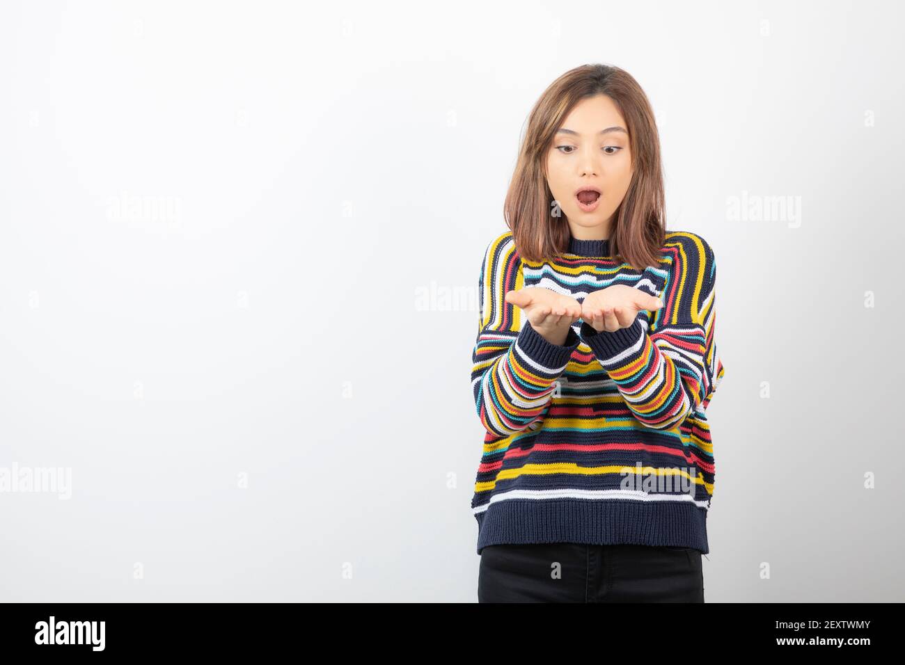 Portrait photo of a young woman model showing opened palms Stock Photo ...
