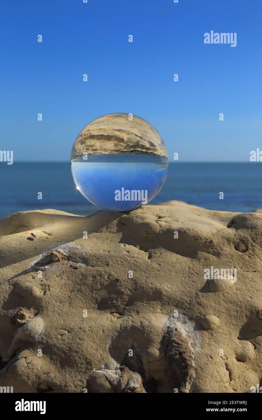 Clear glass ball sphere on the rock Stock Photo - Alamy