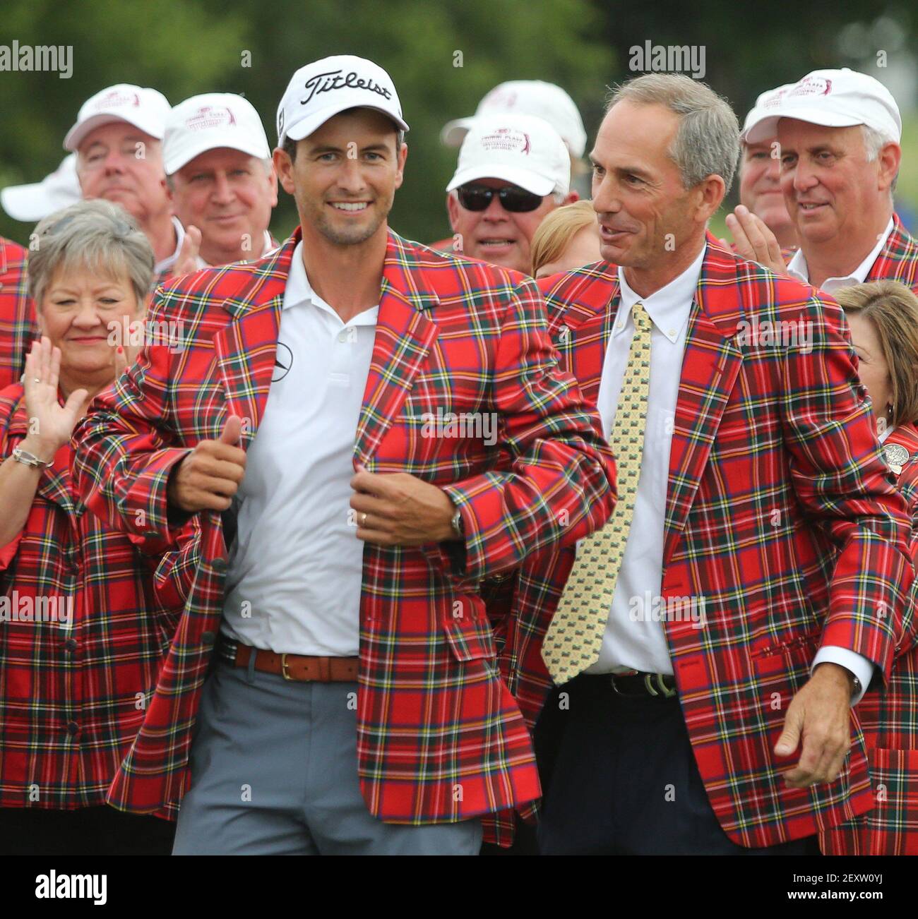 Adam Scott, left, accepts the winners plaid jacket from Colonial golf ...