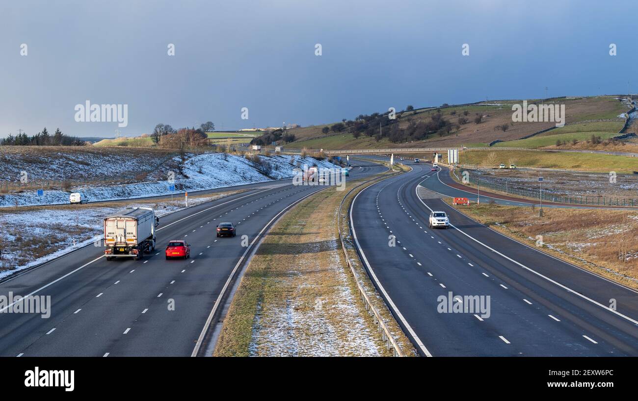 Traffic on the M6 Motorway at Shap in Cumbria on a winters evening ...