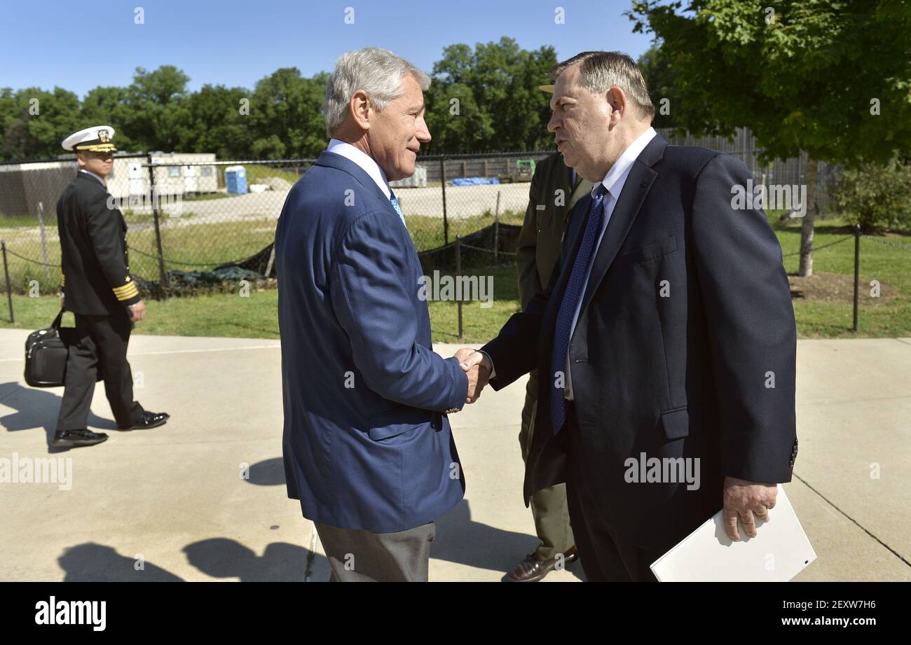 Secretary of Defense Chuck Hagel is greeted by Lt. Gen. Claude "Mick ...