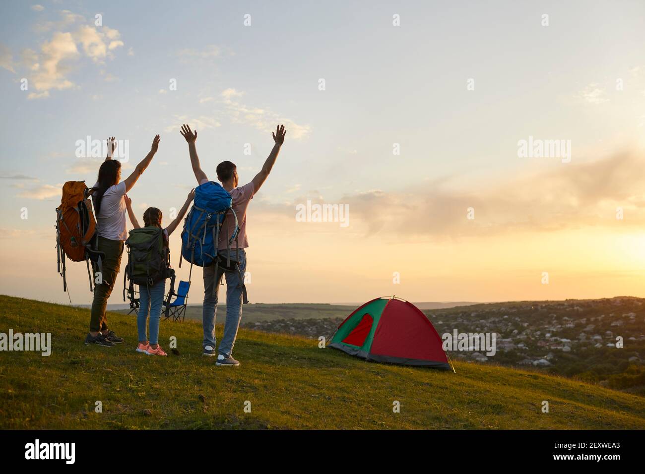 Family camping in nature. Parents and child with backpacks enjoying ...