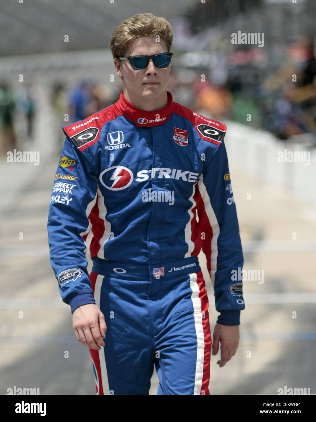 Josef Newgarden walks down pit lane after his qualifying run for the ...