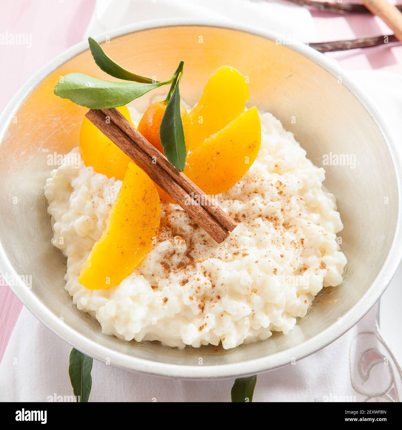 Rice pudding with peaches and cinnamon Stock Photo - Alamy