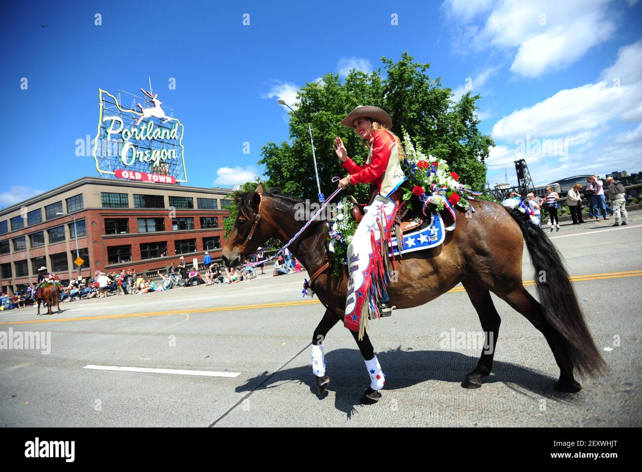 A Wild Rogue rodeo queen waves to the crowd on the Burnside Bridge ...