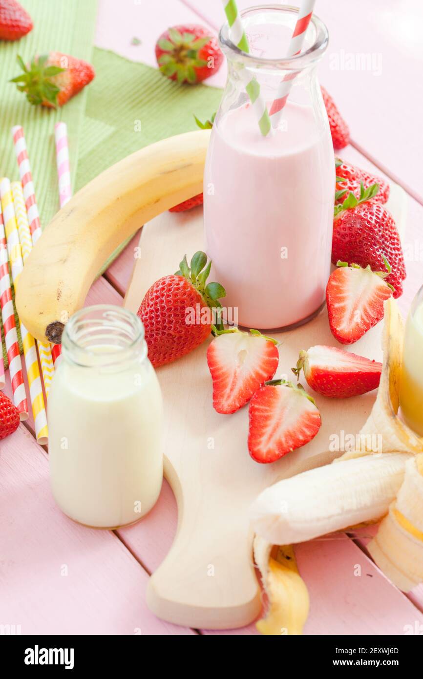 Milk with fresh strawberries and banana Stock Photo - Alamy
