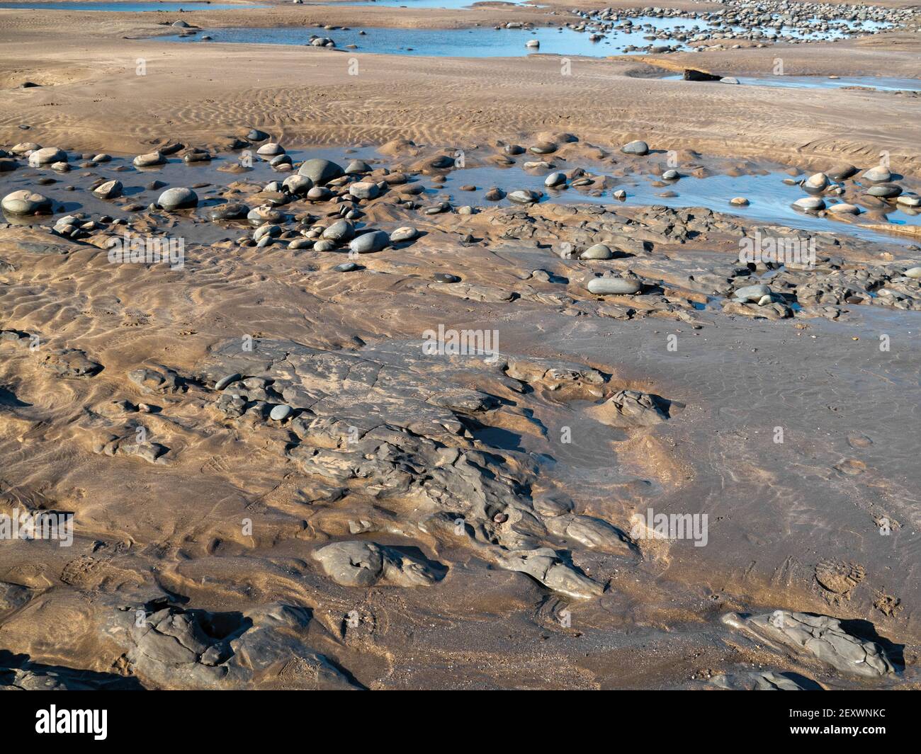 Clay exposed under sand, coastal erosion after bad weather. UK Stock ...