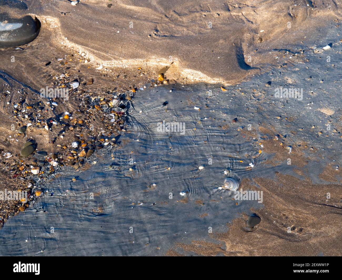 Clay exposed under sand, coastal erosion after bad weather. UK Stock ...