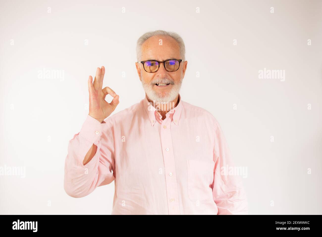 happy positive handsome old man shows okay sign over white background ...
