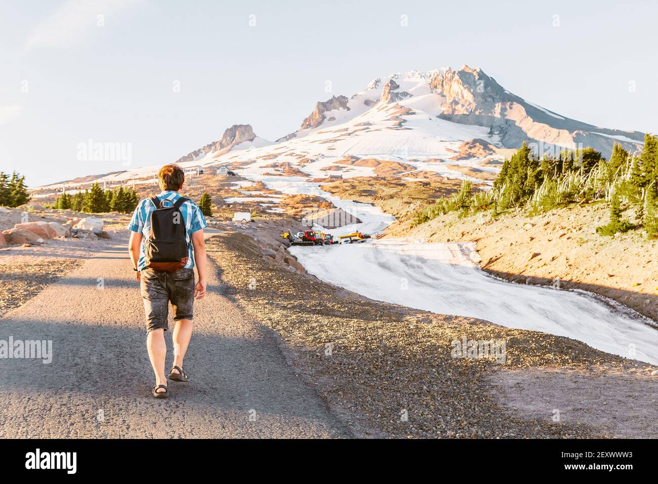 White man hiking in the snow top Mountains in the Summer. Route to the ...