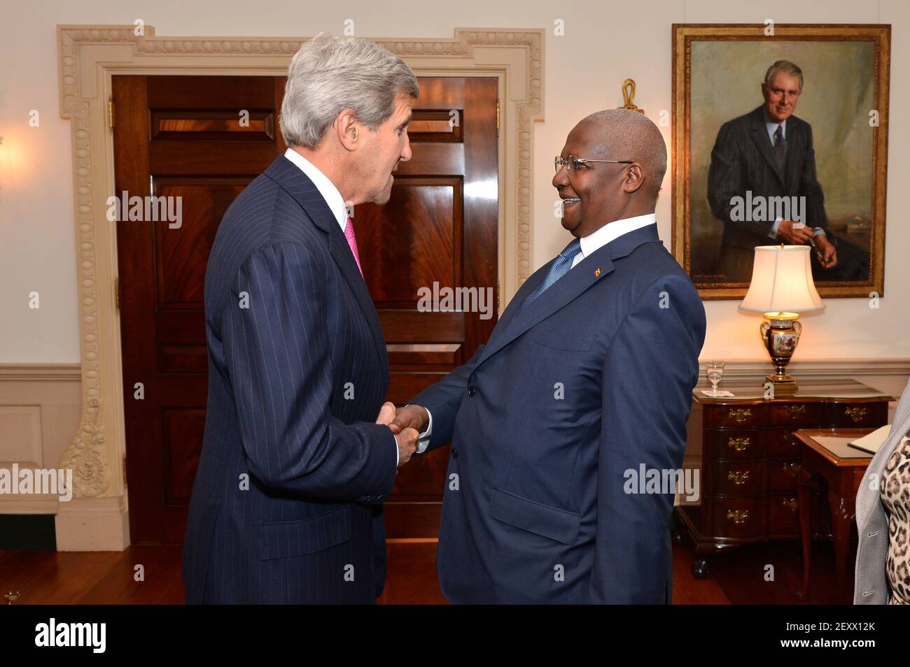 U.S. Secretary of State John Kerry shakes hands with Ugandan Foreign ...