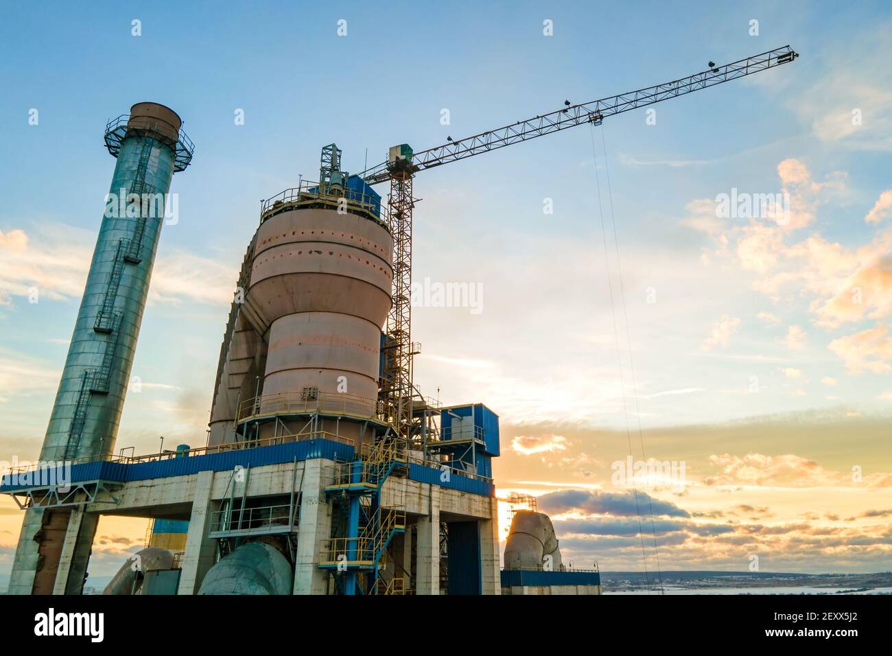 Aerial view of cement plant with high factory structure and tower crane ...
