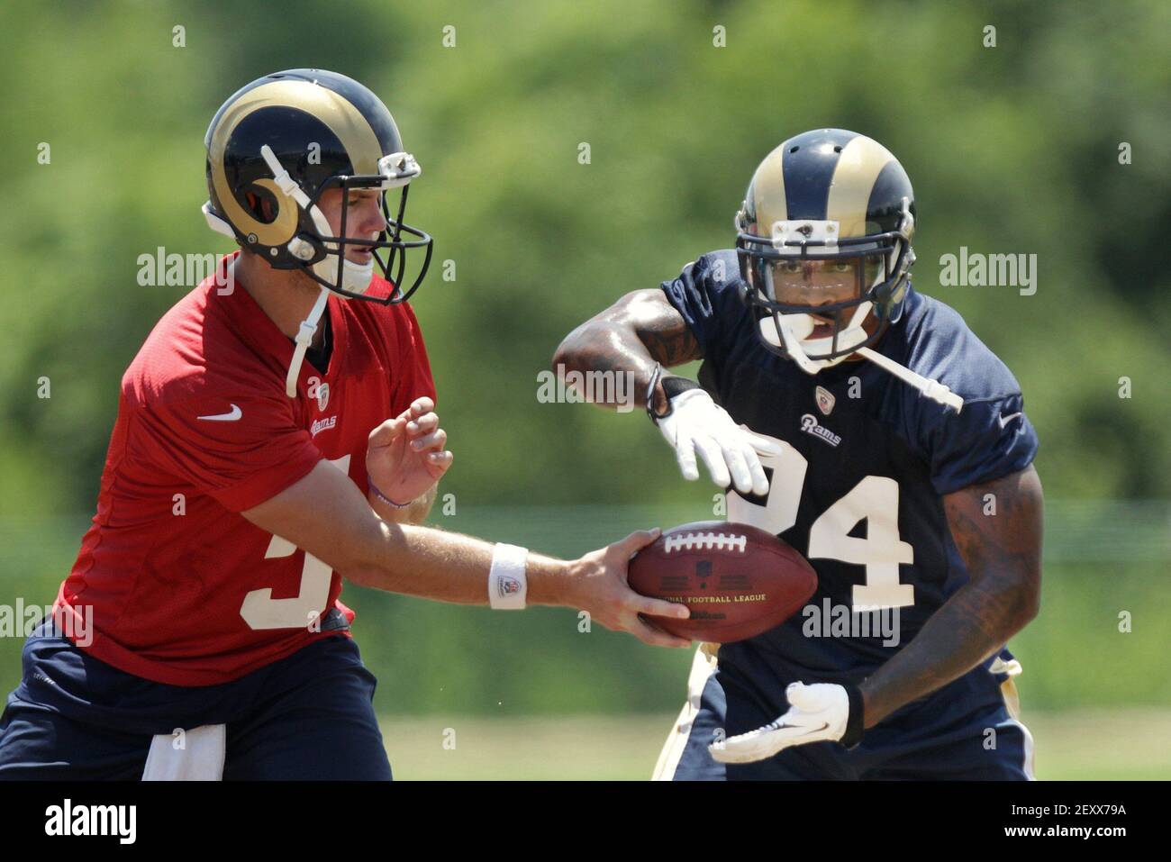 St. Louis Rams quarterback Garrett Gilbert hands off to running back ...