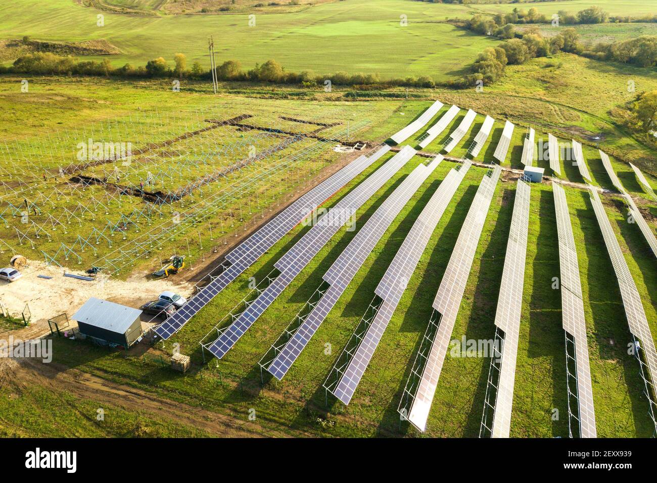 Aerial view of solar power plant under construction on green field ...