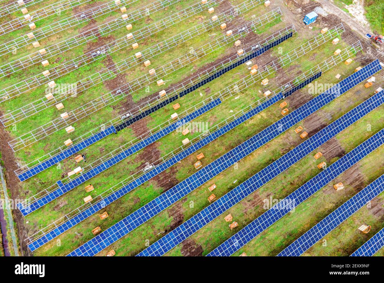 Aerial view of solar power plant under construction on green field ...