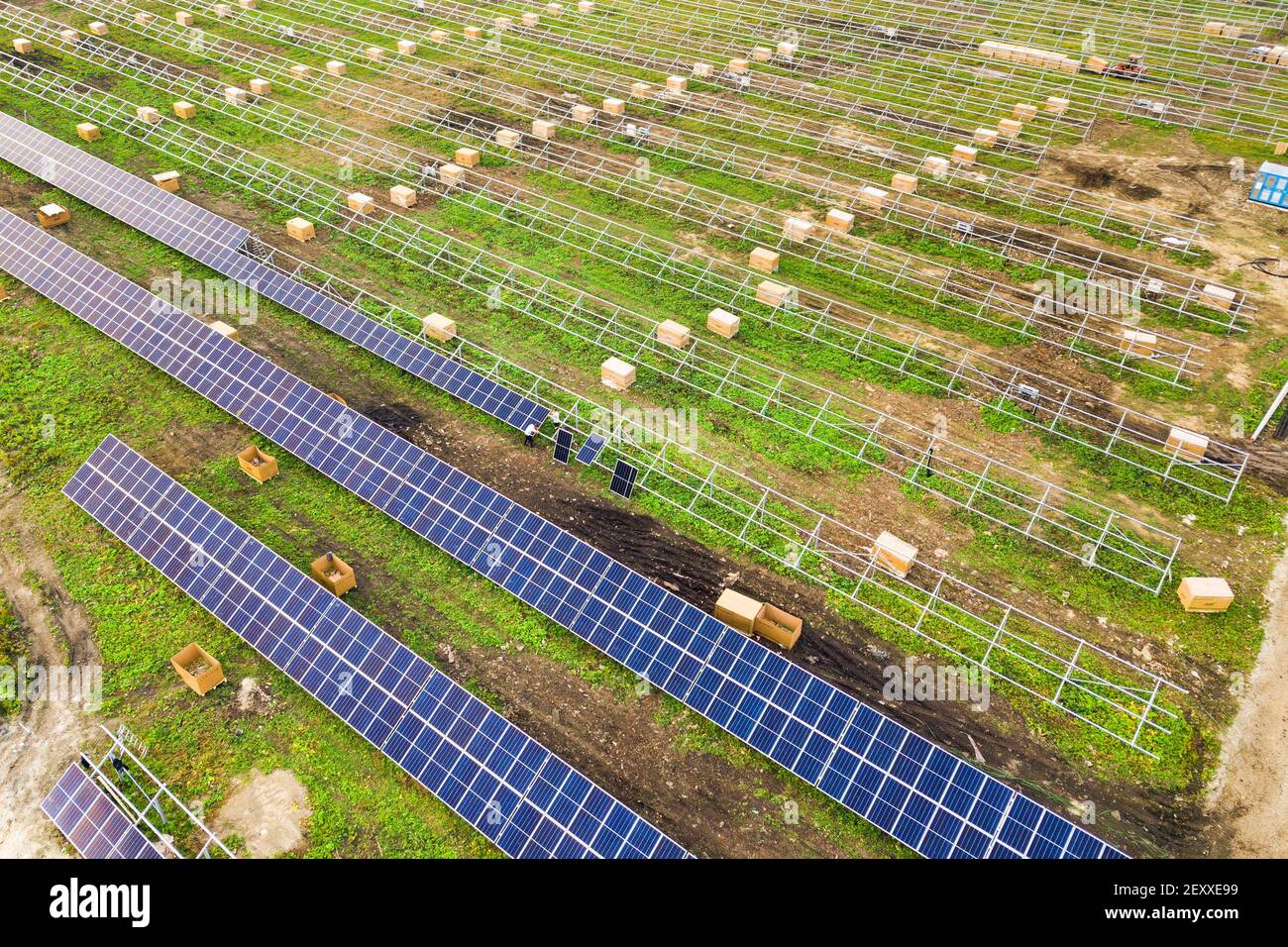 Aerial view of solar power plant under construction on green field ...