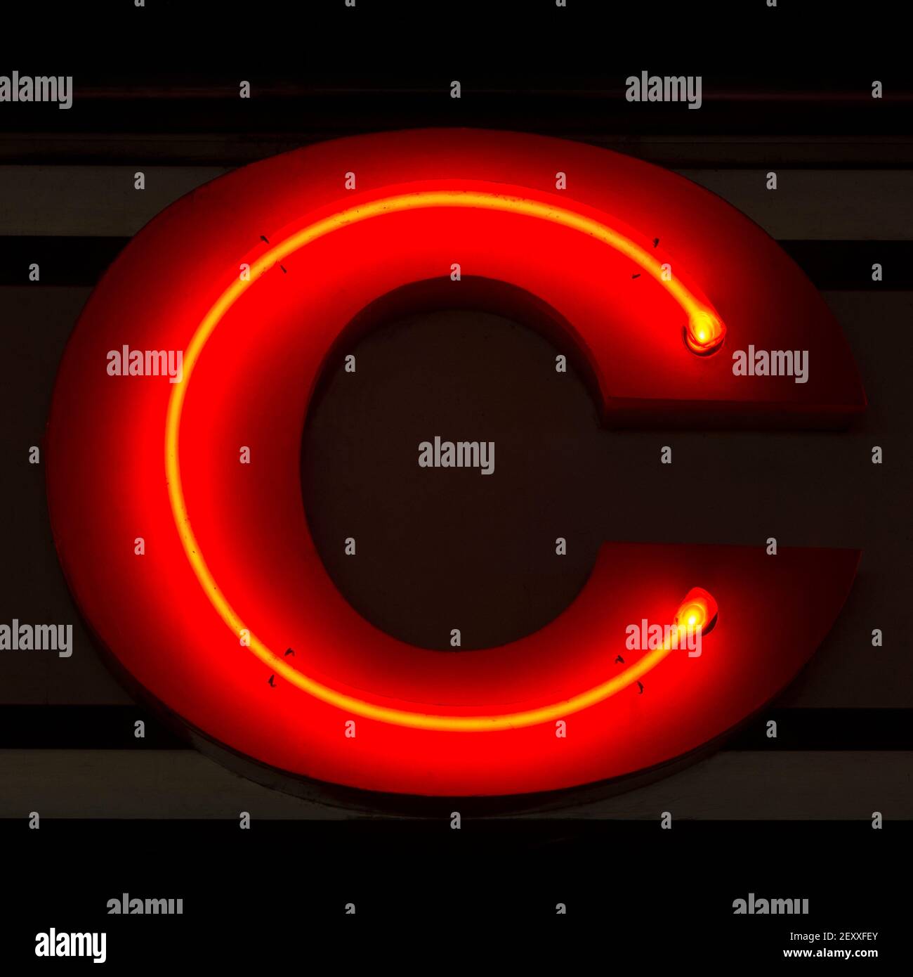 Red glowing neon letter C at night Stock Photo - Alamy