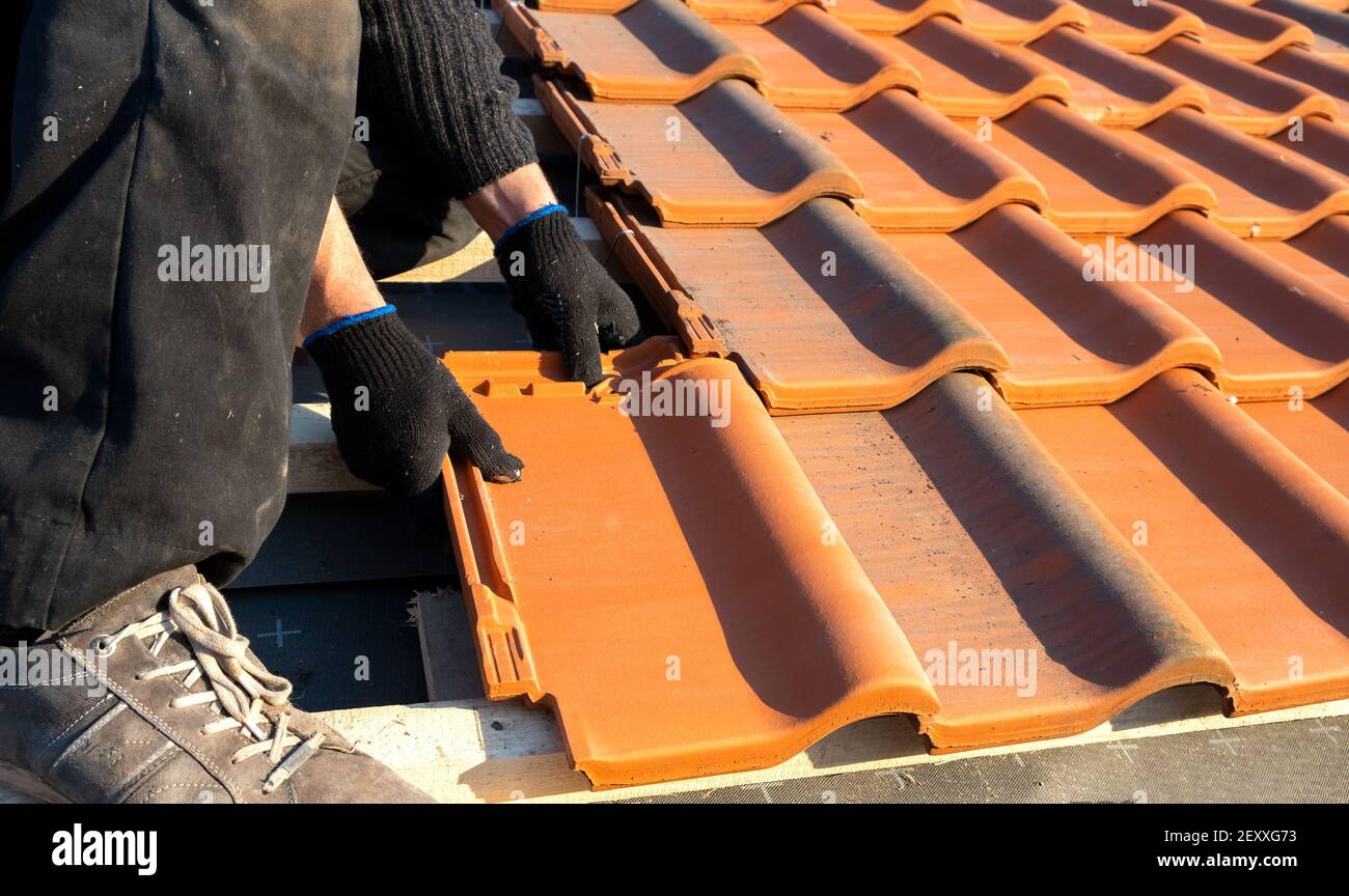 Man fixing roof tiles hi-res stock photography and images - Alamy