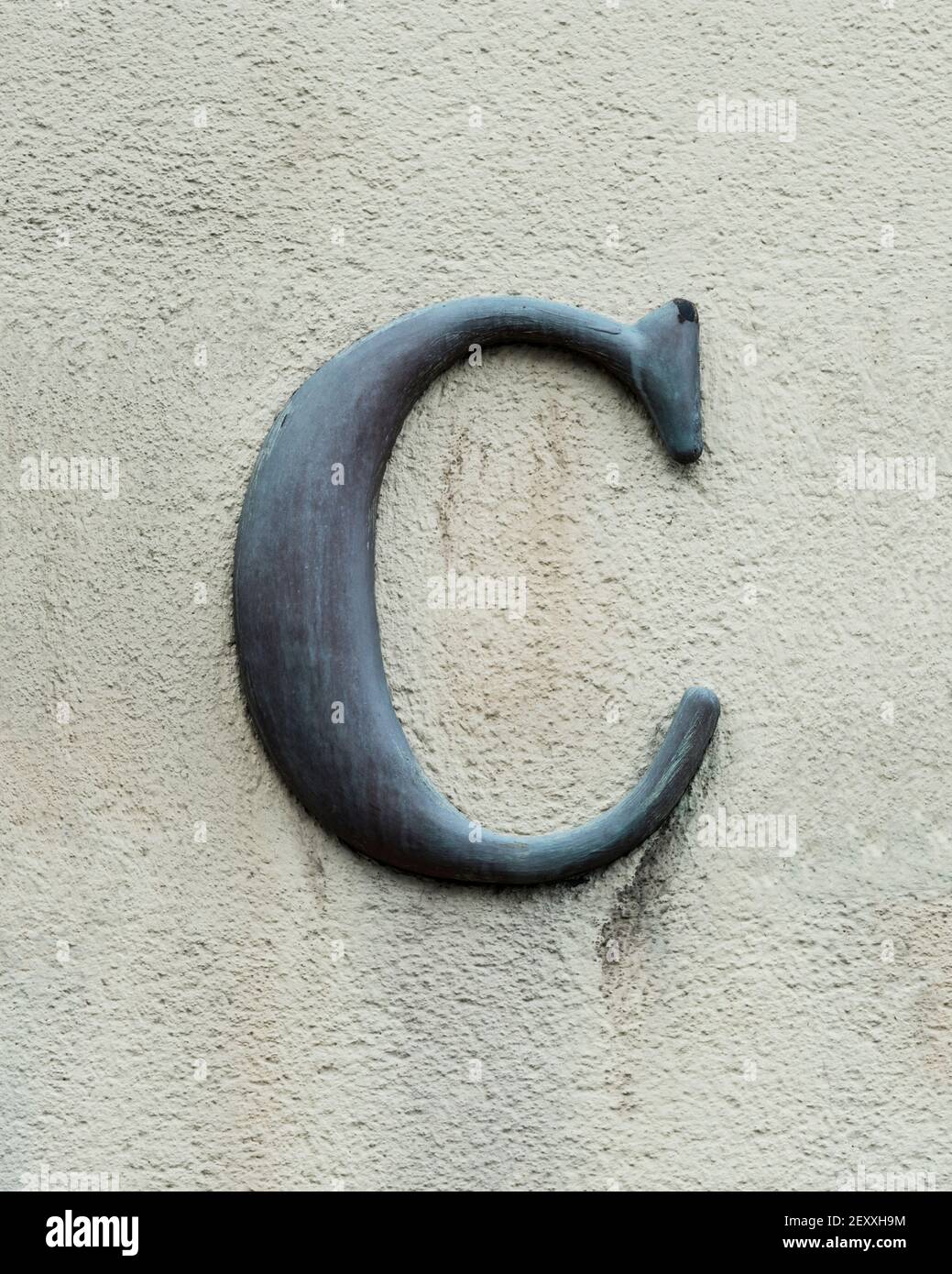 Metal letter C on a house wall Stock Photo - Alamy
