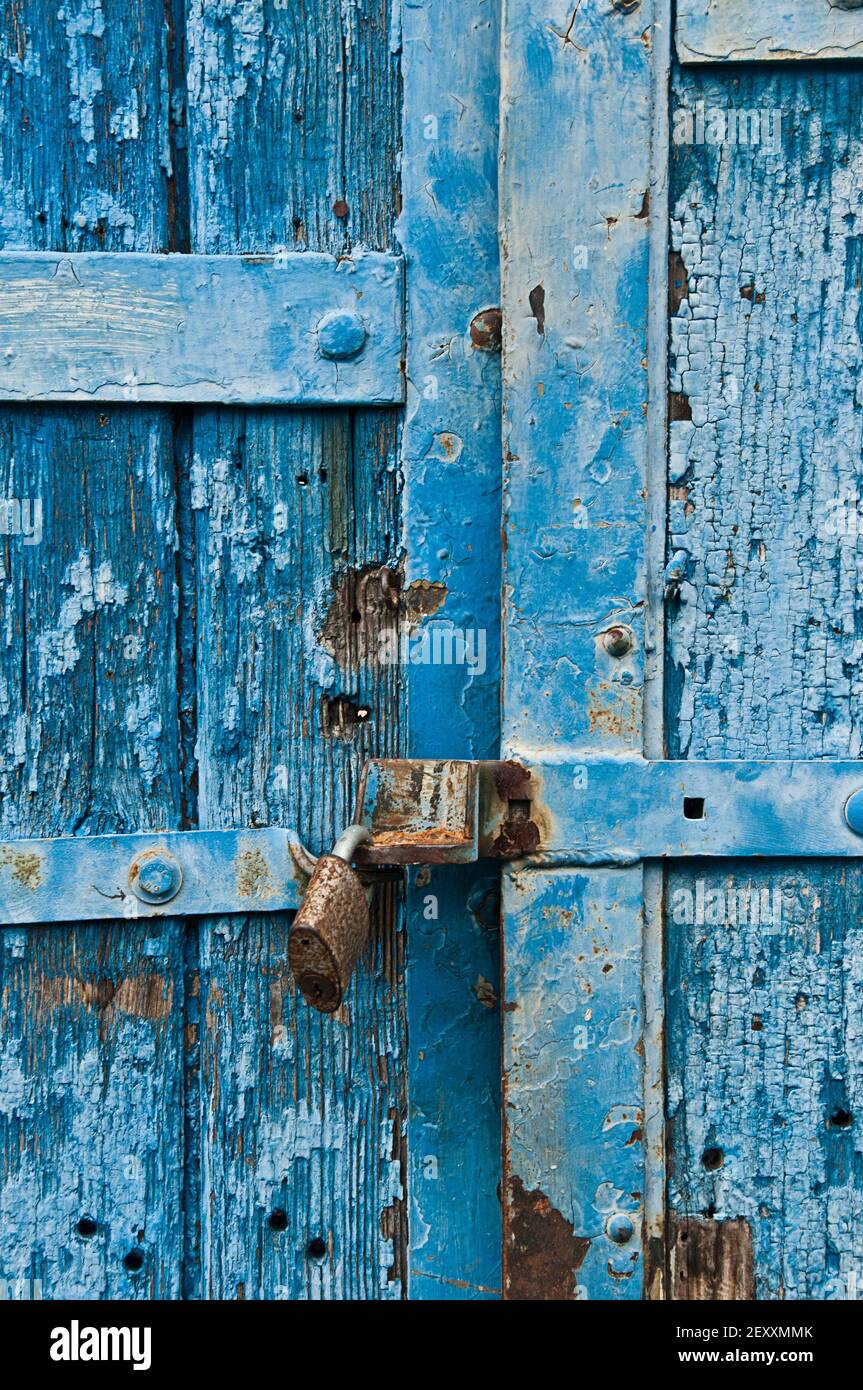 old blue wooden door in decay with a metal lock Stock Photo - Alamy