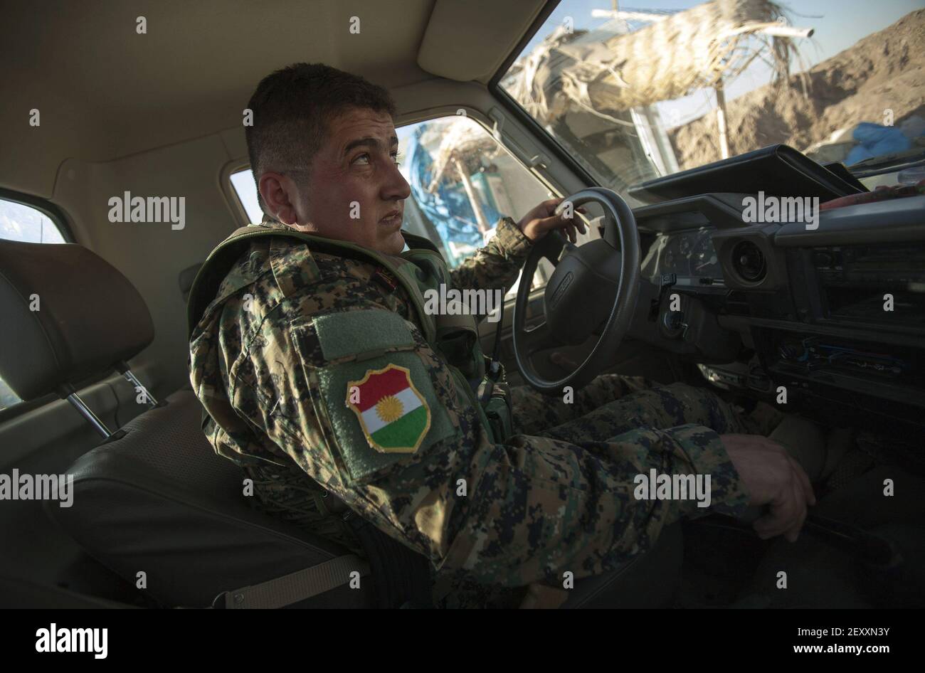 Kurdish Peshmerga fighters along a frontline position protect the main ...