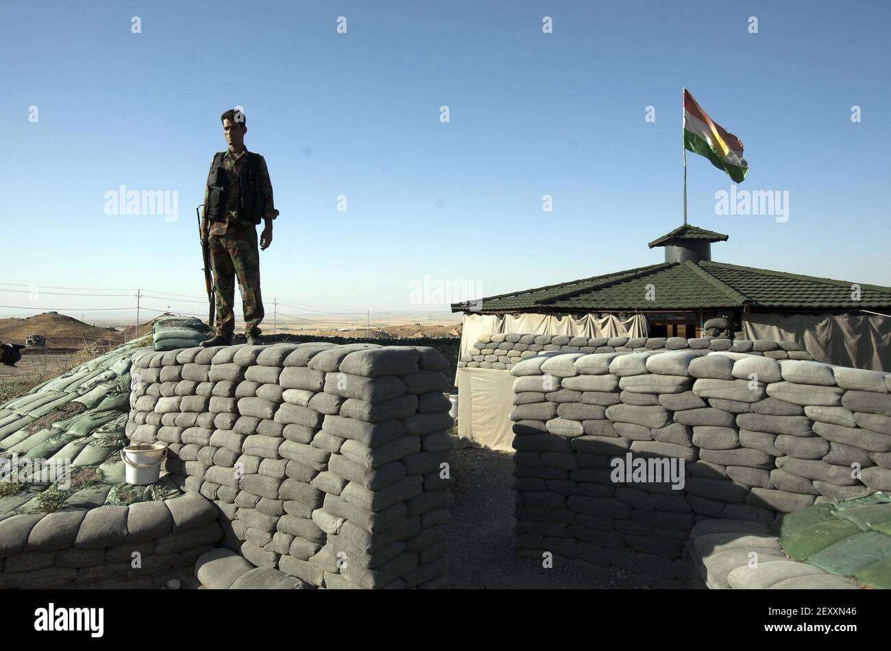 Kurdish Peshmerga fighters along a frontline position protect the main ...