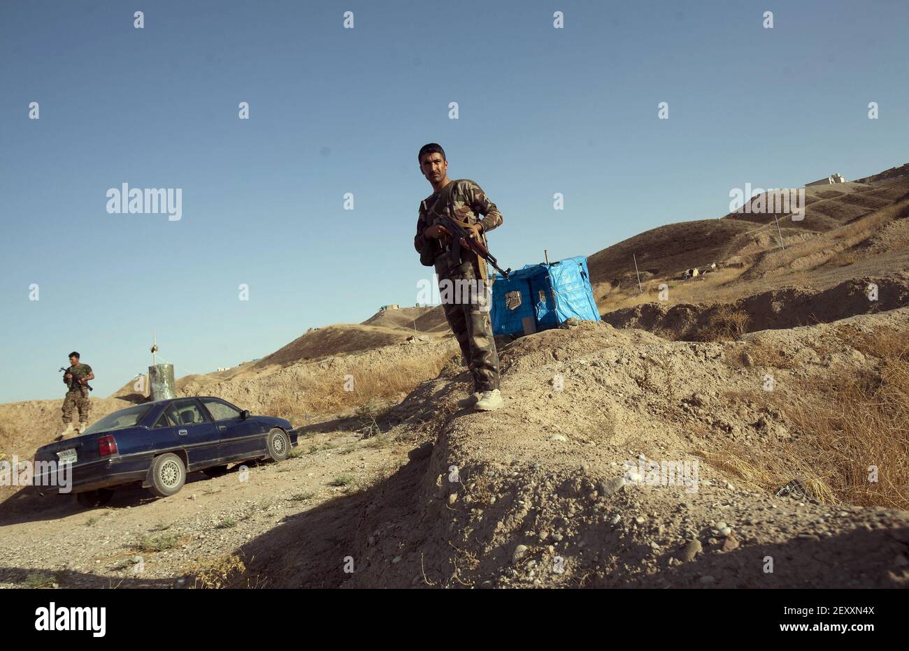 Kurdish Peshmerga fighters along a frontline position protect the main ...