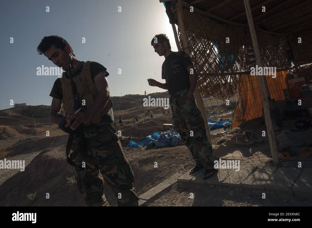 Kurdish Peshmerga fighters along a frontline position protect the main ...