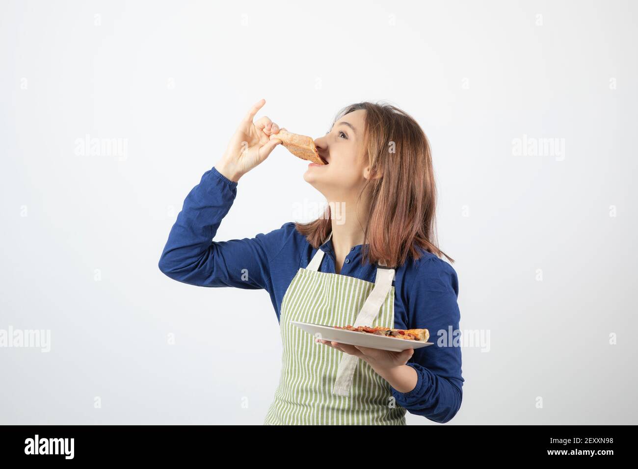 Portrait of young pretty girl eating pizza on white background Stock ...