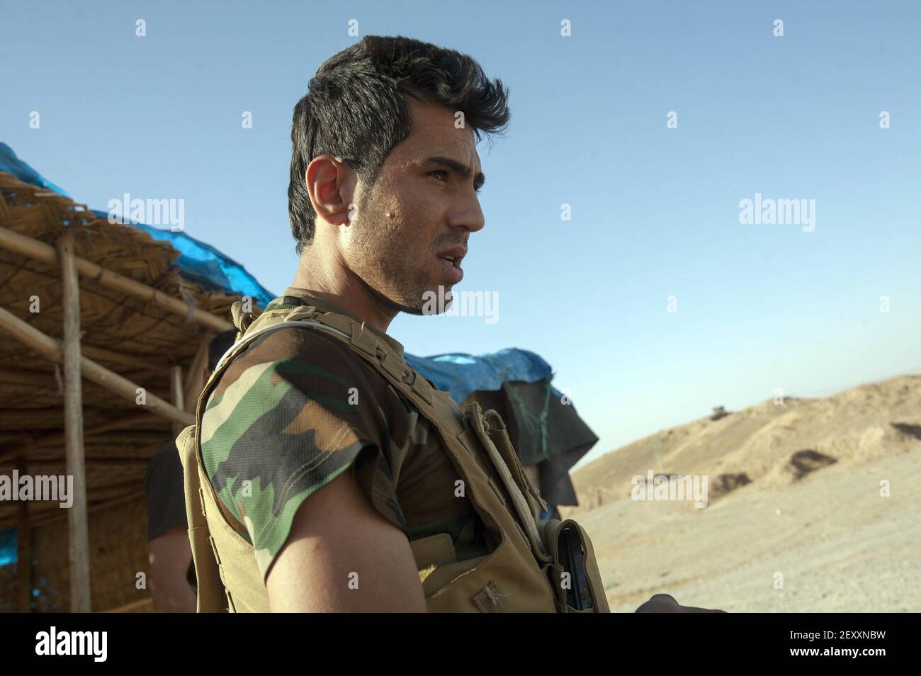 Kurdish Peshmerga fighters along a frontline position protect the main ...