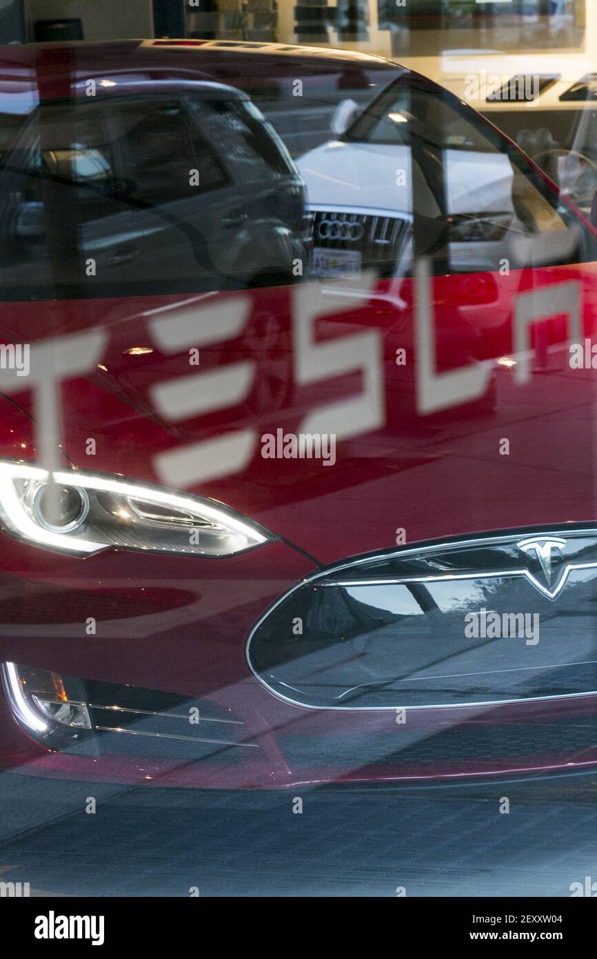 A Tesla Model S electric car is seen through the window of the downtown ...