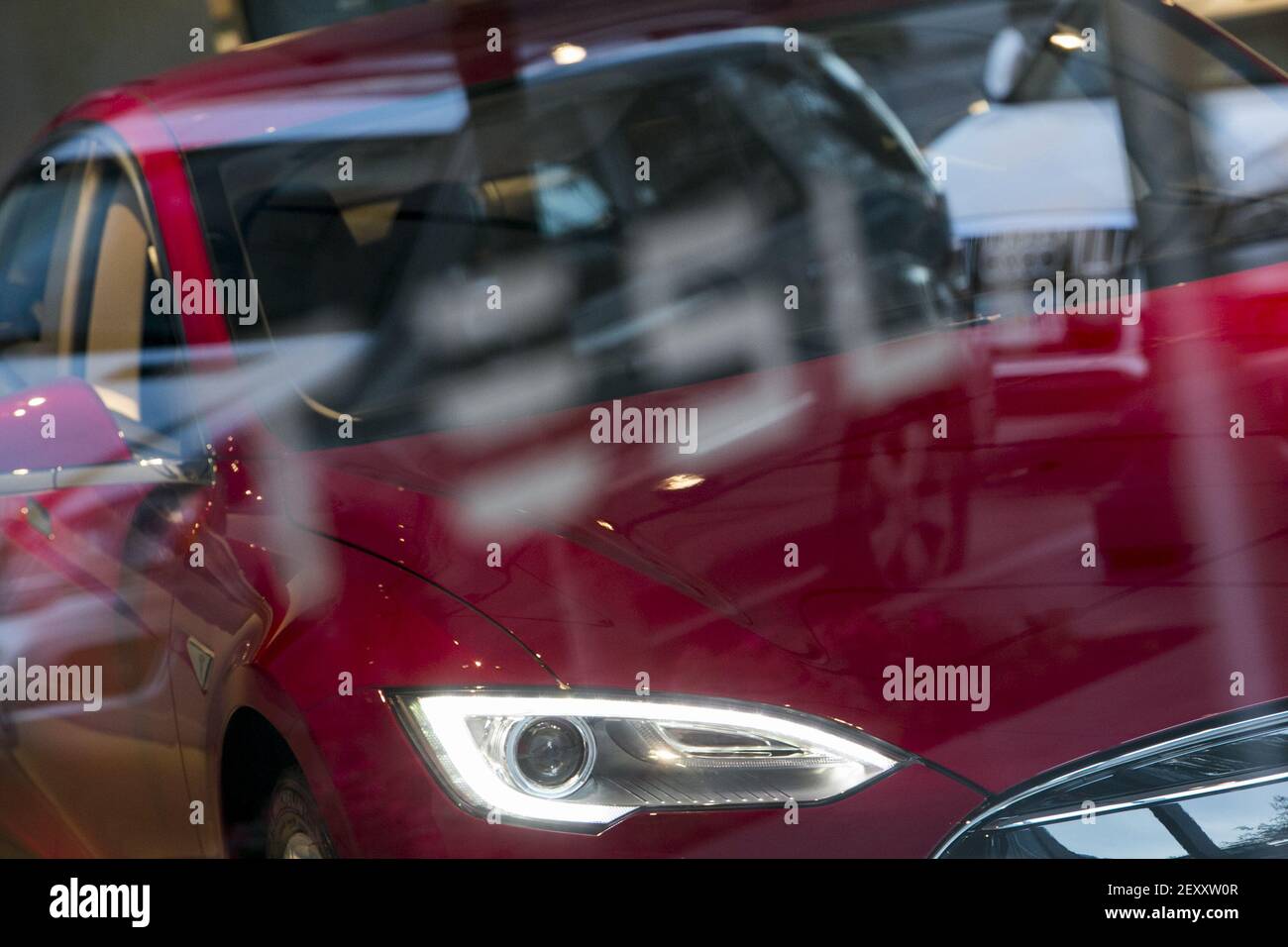 A Tesla Model S electric car is seen through the window of the downtown ...