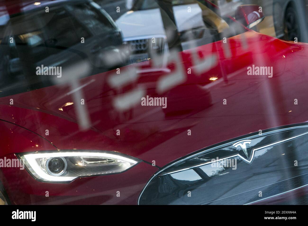 A Tesla Model S electric car is seen through the window of the downtown ...
