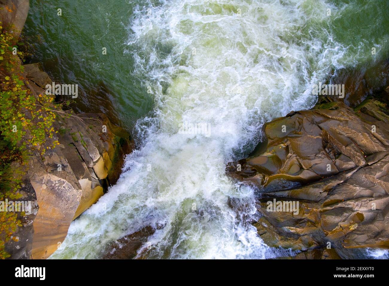 Aerial view of river waterfall with clear turquoise water falling down ...