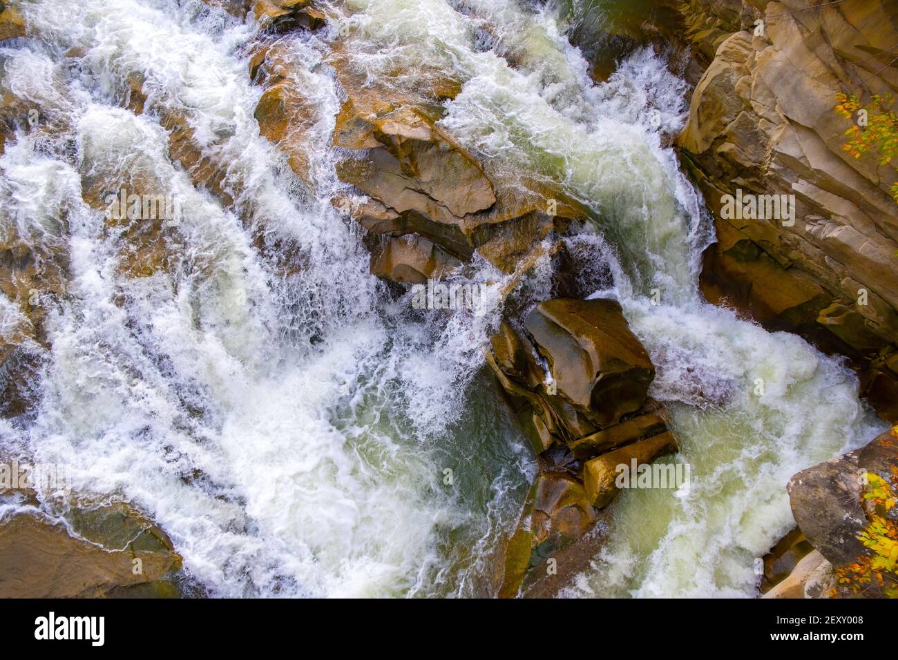 Aerial view of river waterfall with clear turquoise water falling down ...