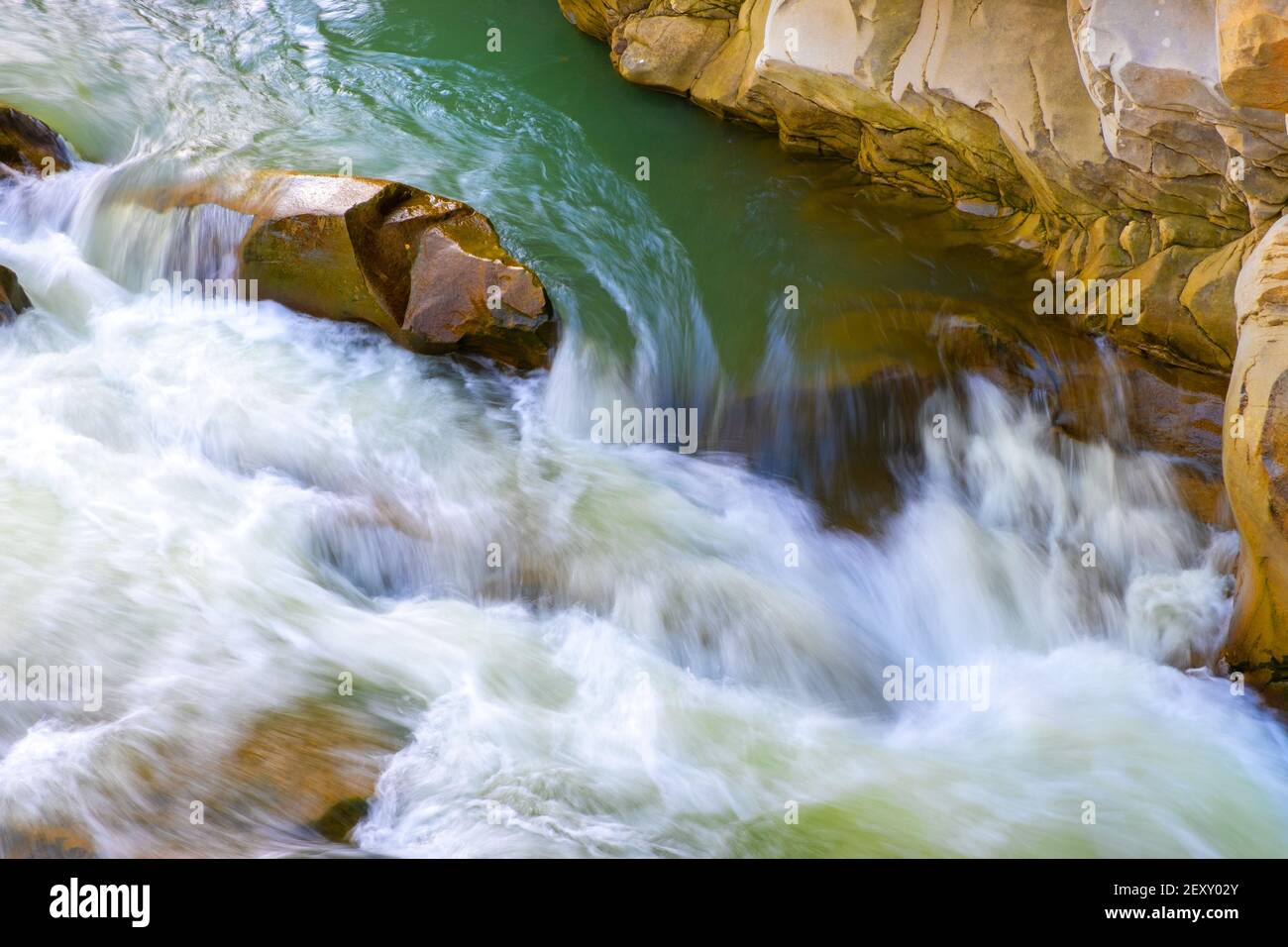 Aerial view of river waterfall with clear turquoise water falling down ...