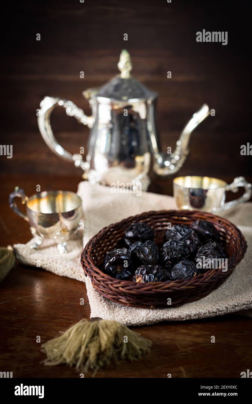 An expensive Ajwa dates on the wooden bowl Stock Photo - Alamy