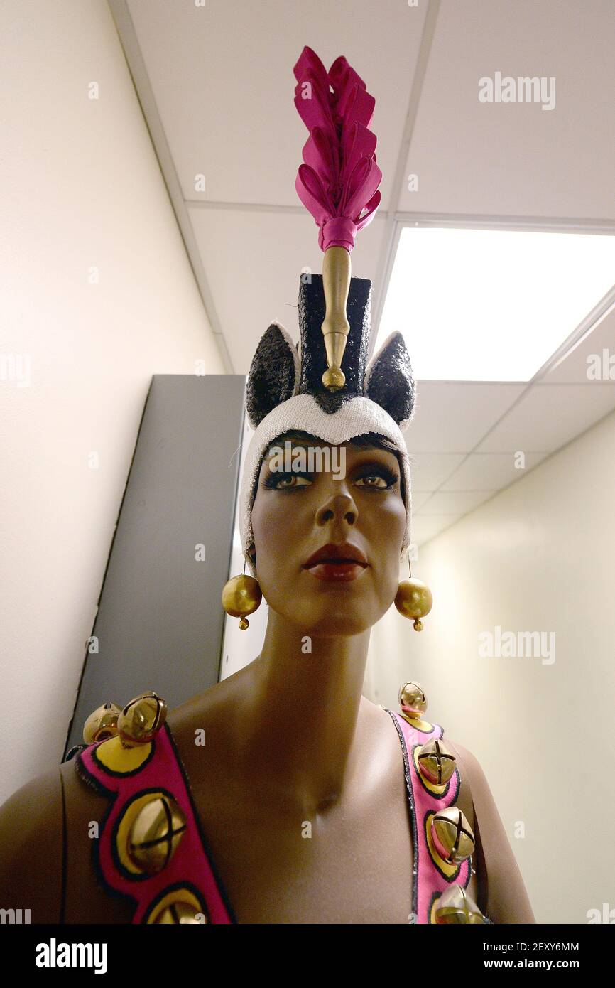 A mannequin wearing a costume head dress stands in the hallway near the ...